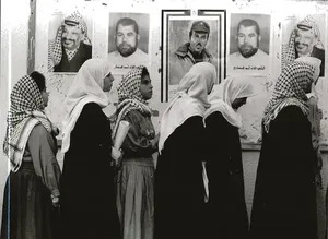 Gaza City, Palestinian woman walk post PLO posters by | David BRAUCHLI ...